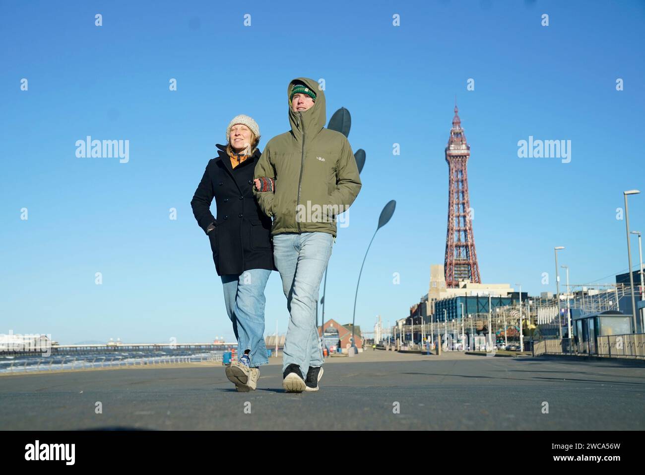 People walk along the promenade on Blackpool's sea front during the ...