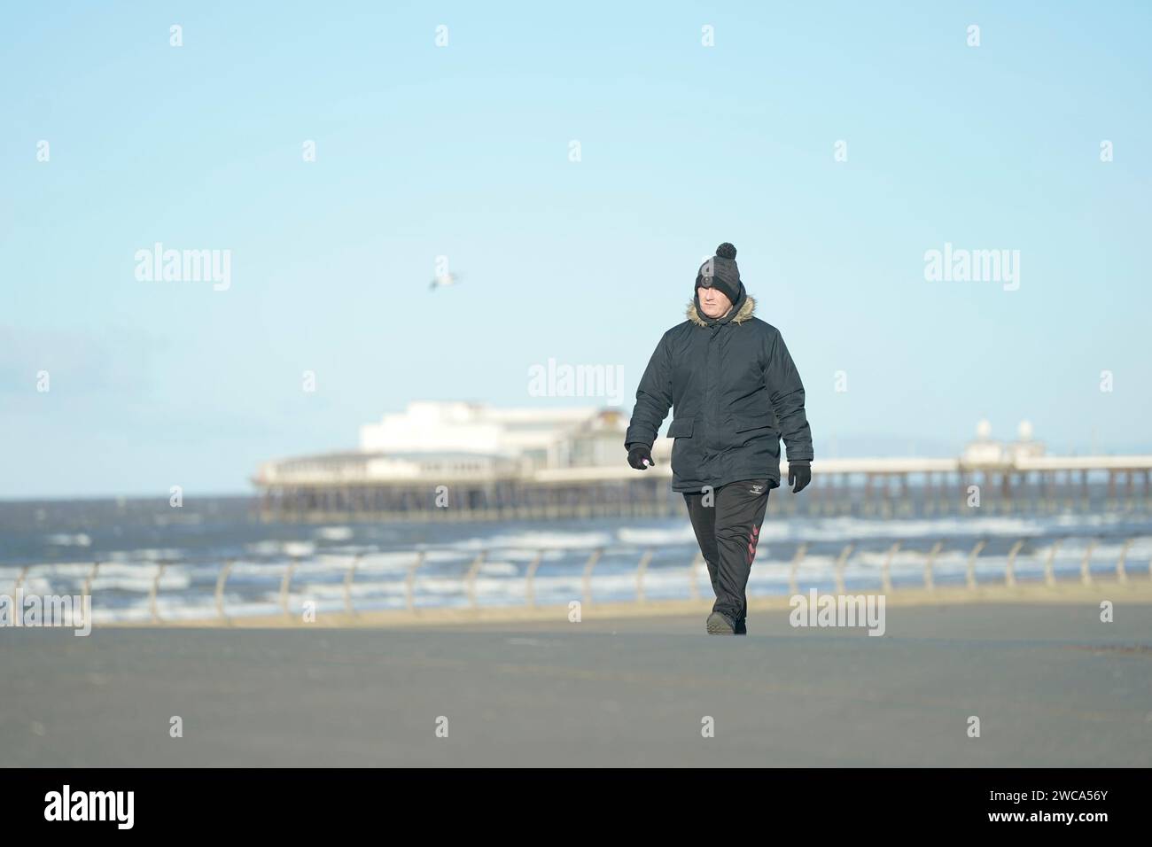 A man walks along the promenade on Blackpool's sea front during the ...