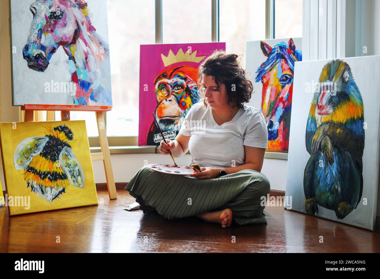 Carefree female painter working in her art studio Stock Photo - Alamy