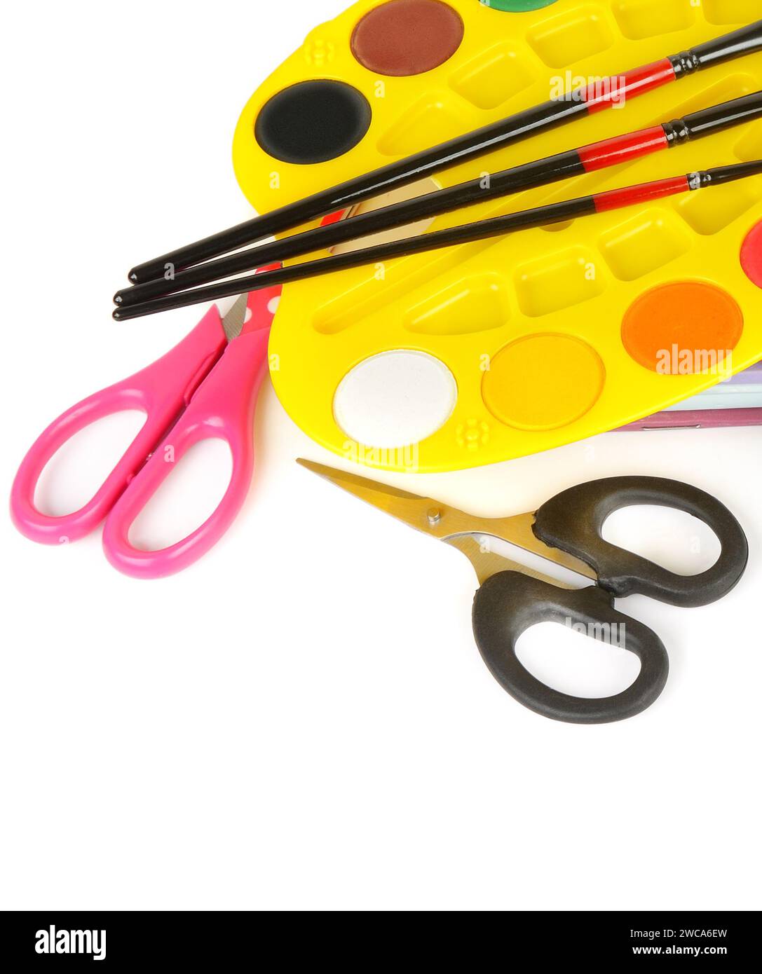 Watercolor paints, scissors and other school supplies isolated on white ...