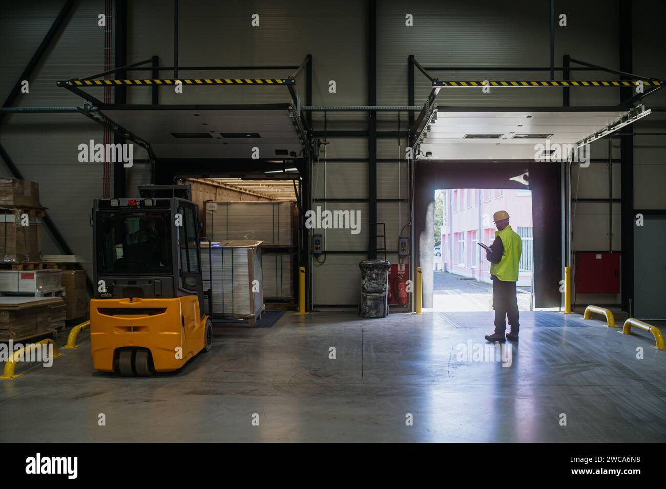 Warehouse receiver overseeing the storing of delivered items, holding ...
