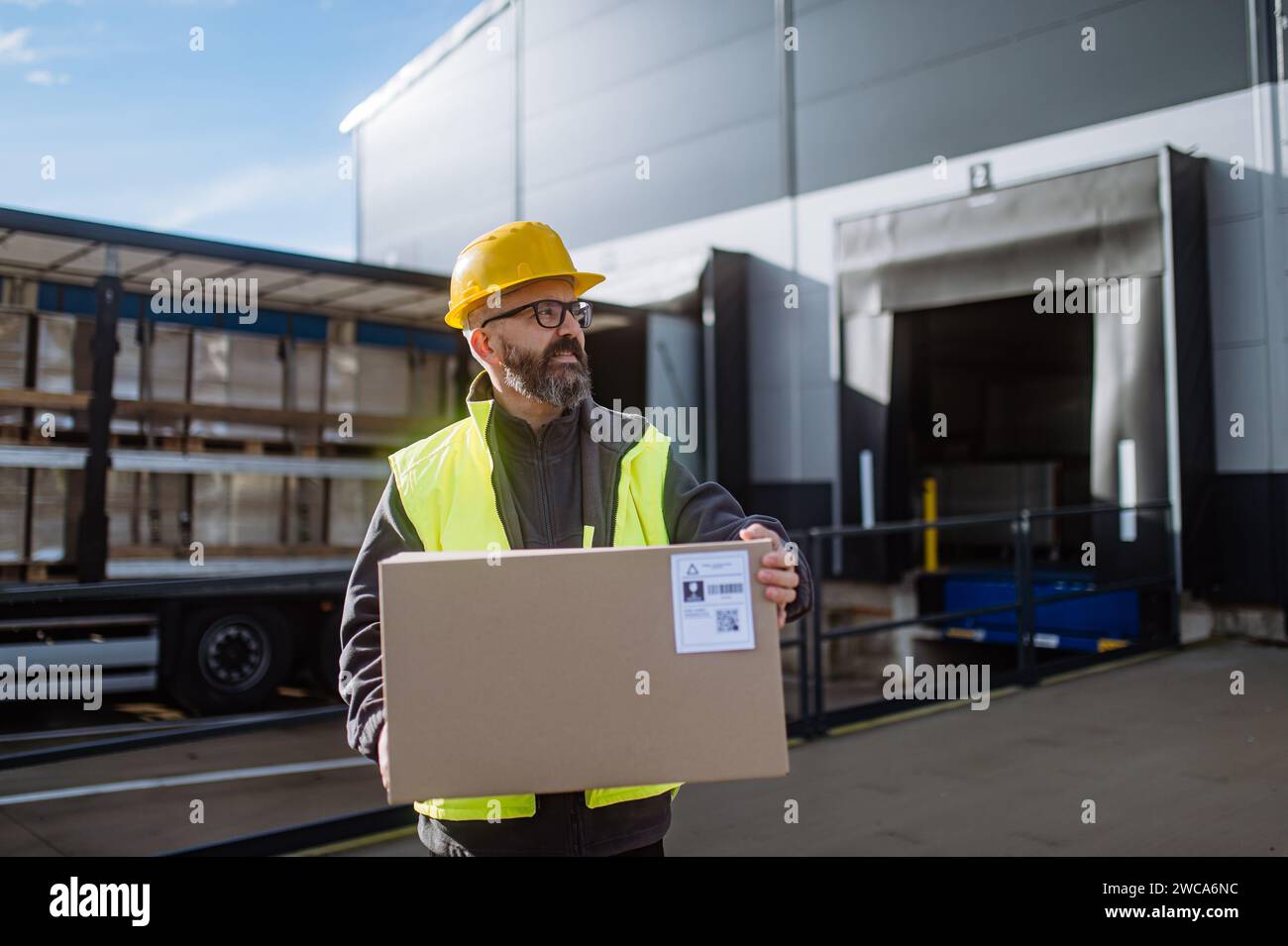 Warehouse receiver unloading truck in front of warehouse, carrying ...