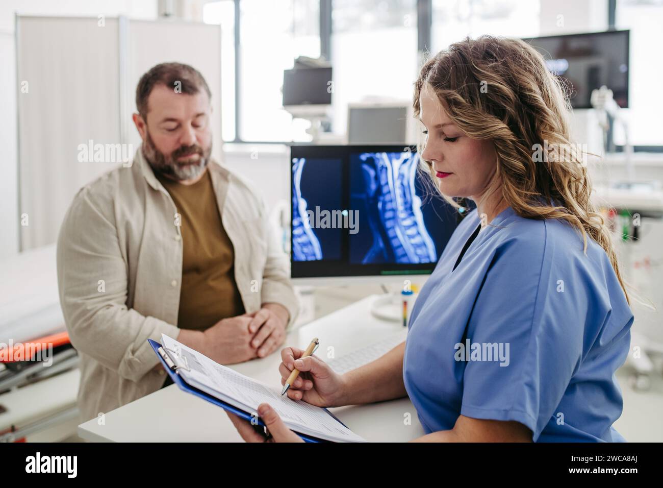 Doctor consulting with overweight patient, discussing test result and x ...