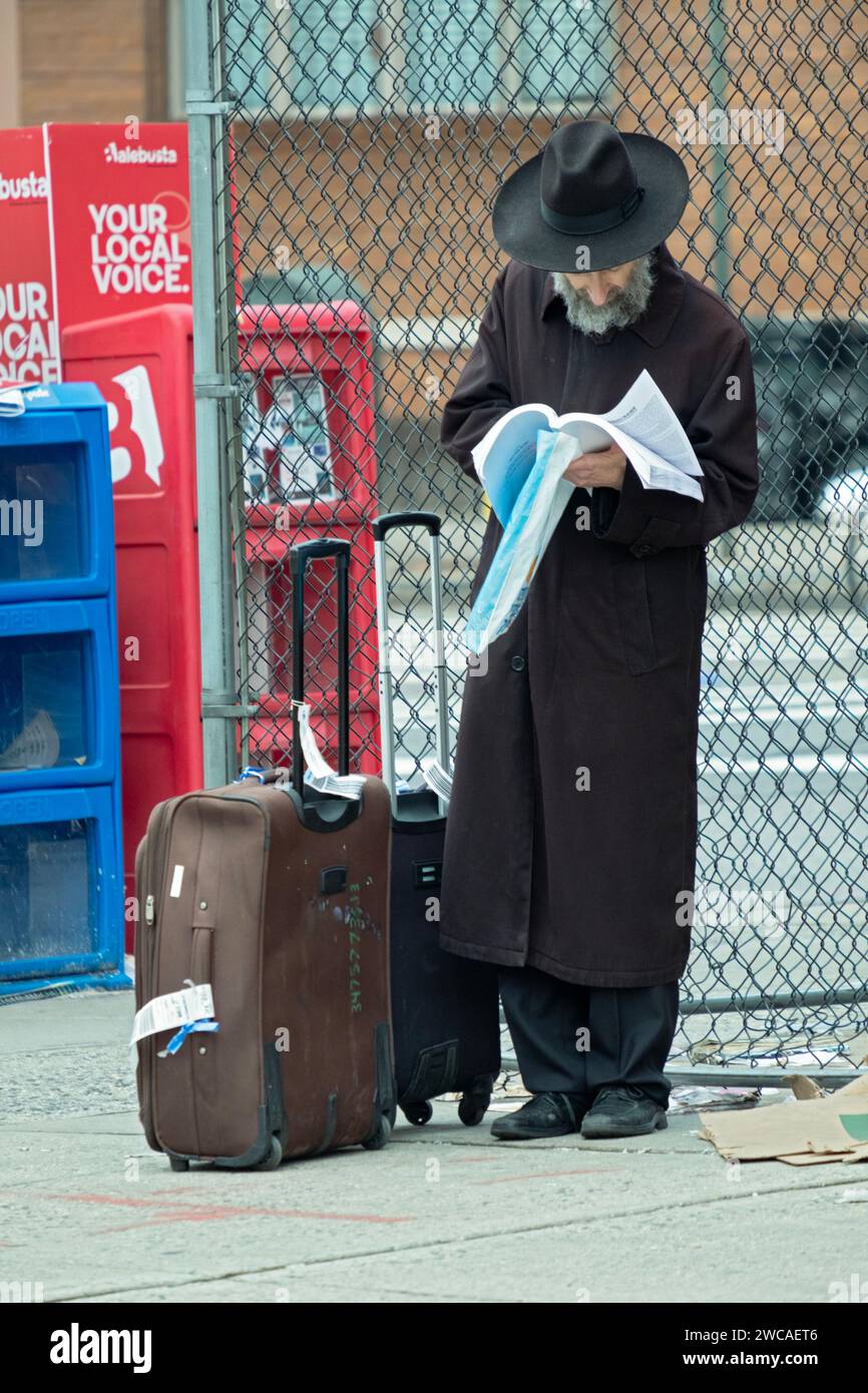 An orthodox man who spent the Sabbath in Williamsburg waits for a bus ...