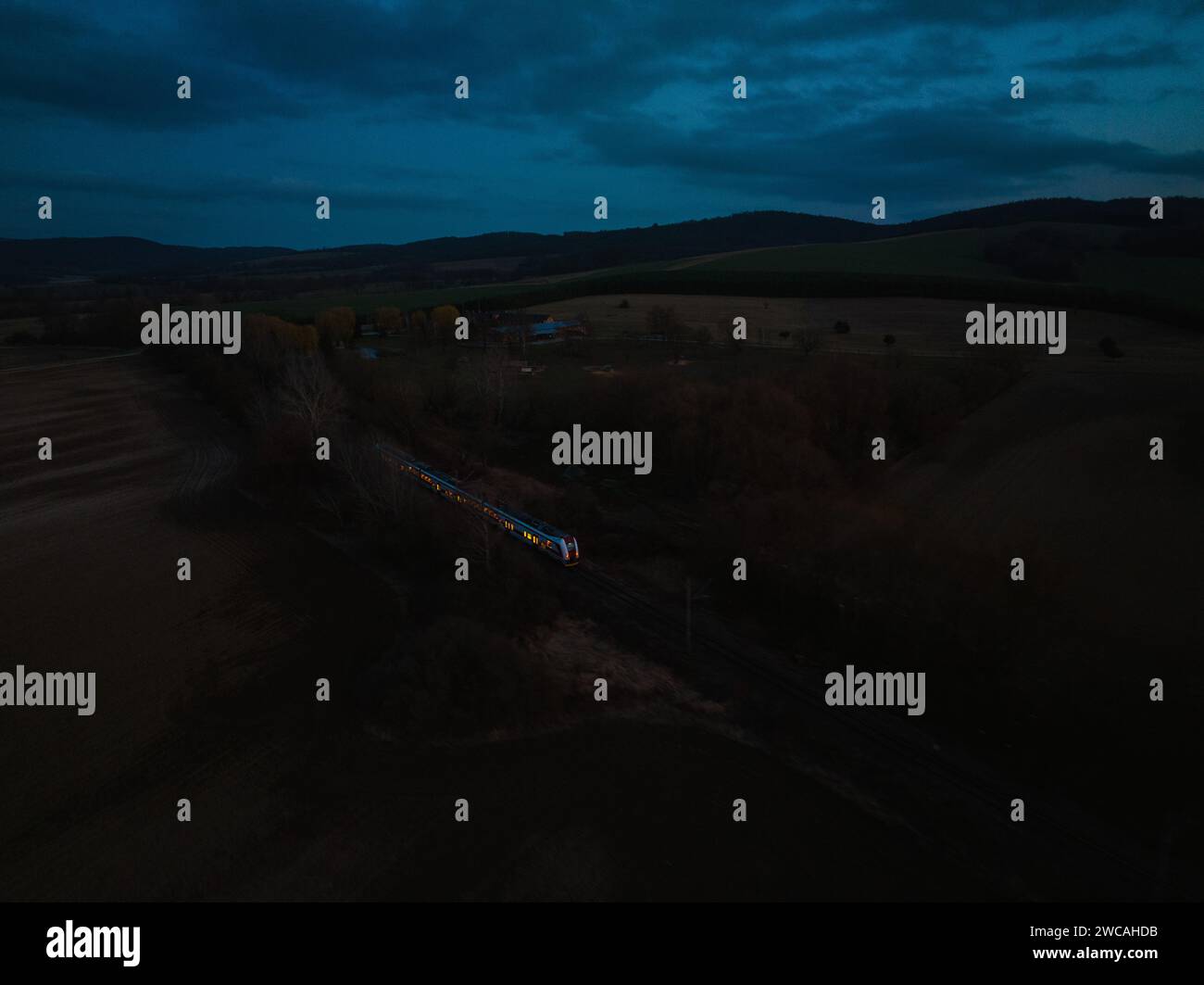 Aerial view of train in the middle of nature, field, during night Stock ...