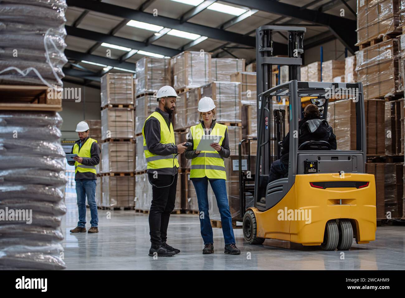 Warehouse workers reading product order, order picking. Warehouse ...