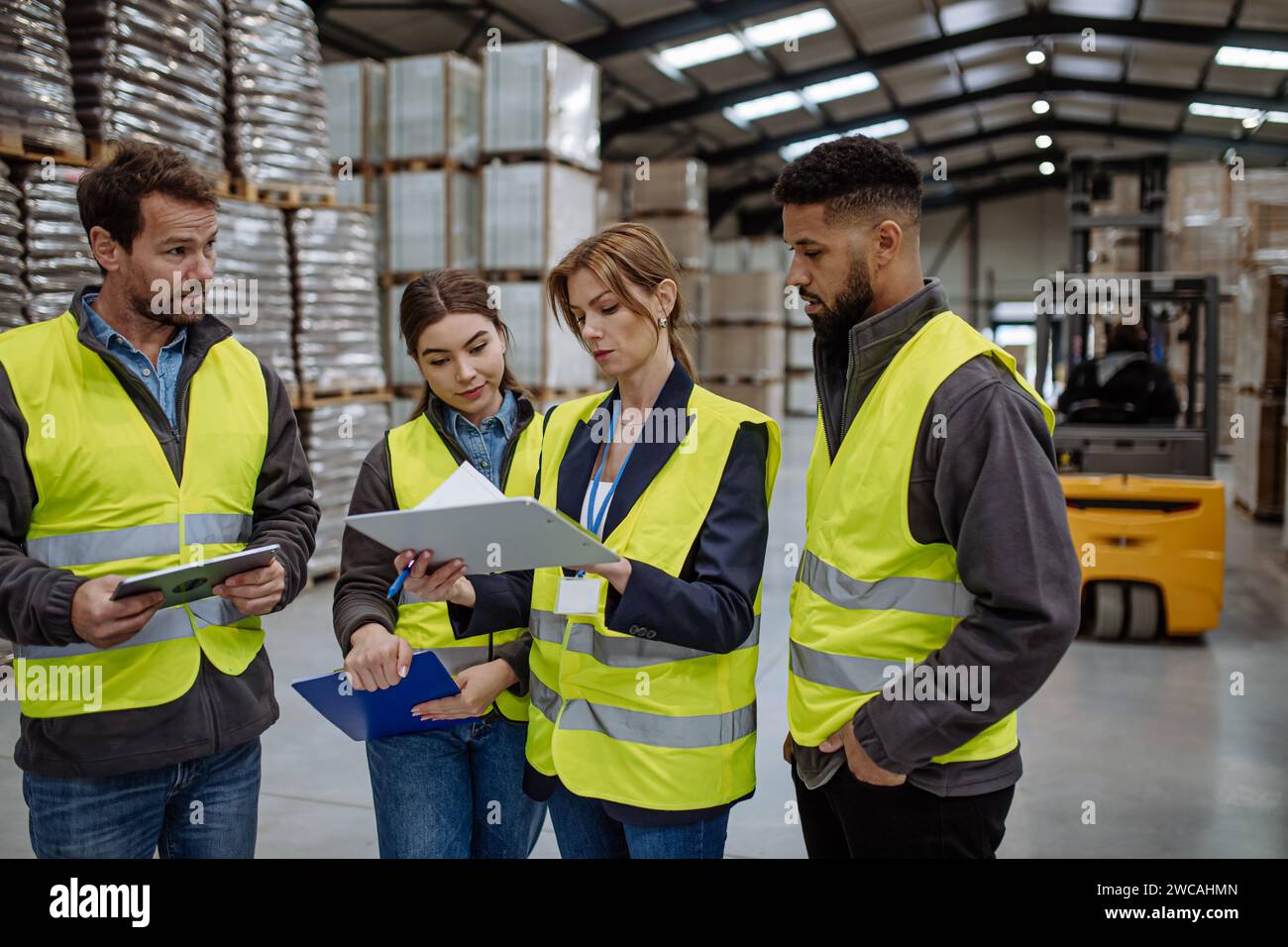 Warehouse workers reading product order, order picking. Warehouse ...
