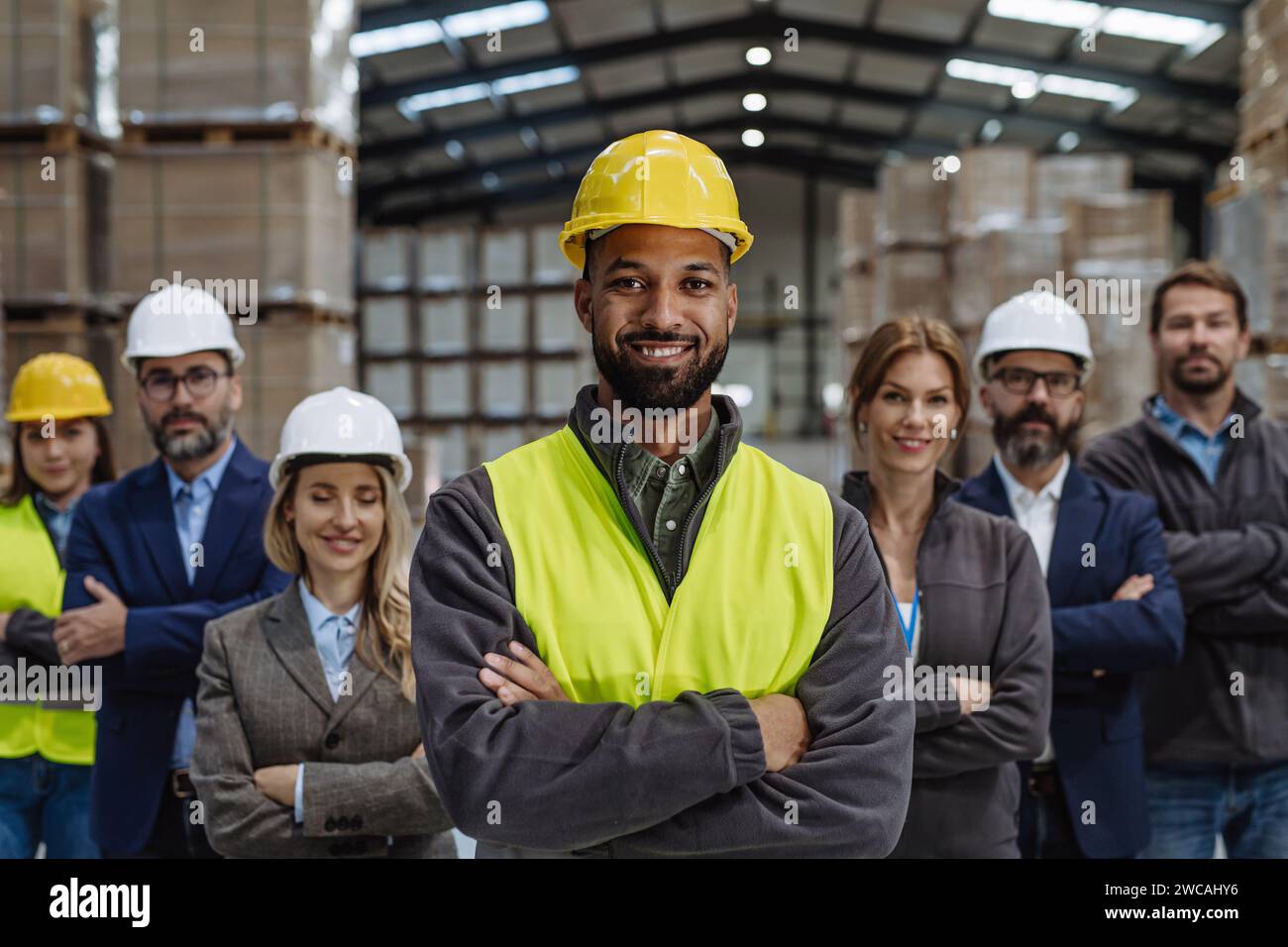 Full team of warehouse employees standing in warehouse. Team of workers ...