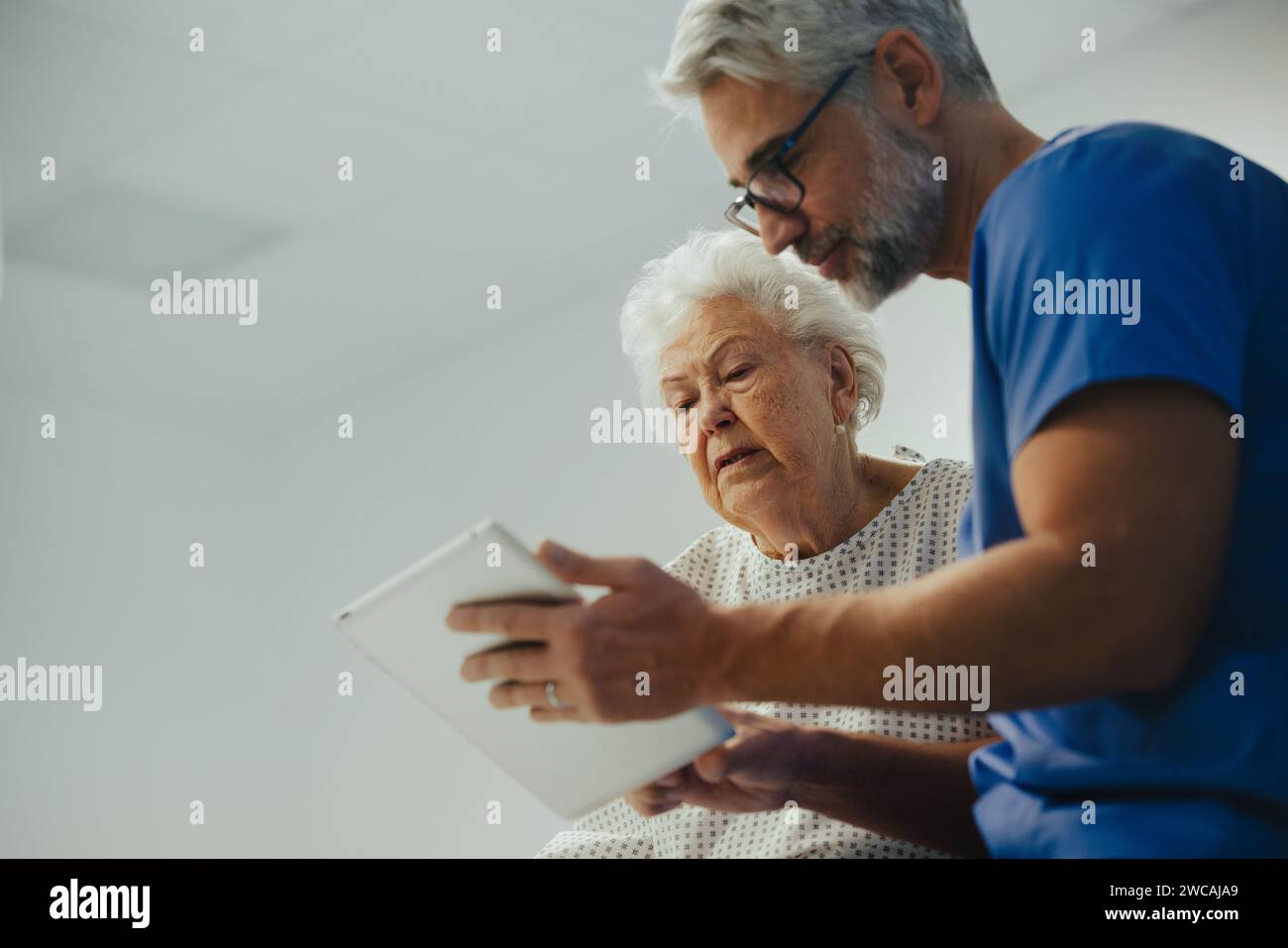 Supportive doctor soothing worried senior patient, discussing test ...