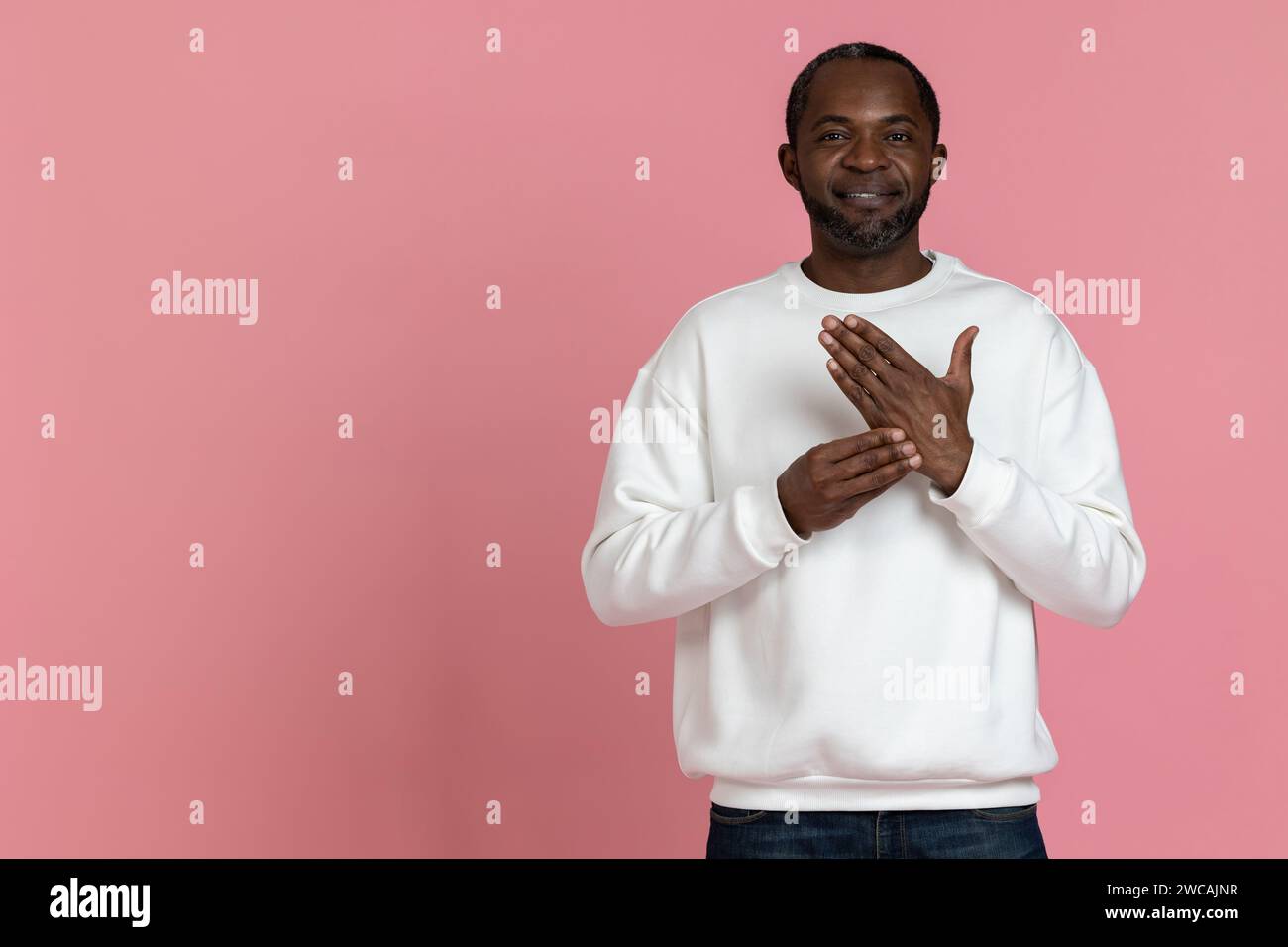 Deaf mute black man wearing white sweatshirt gesturing sign language ...