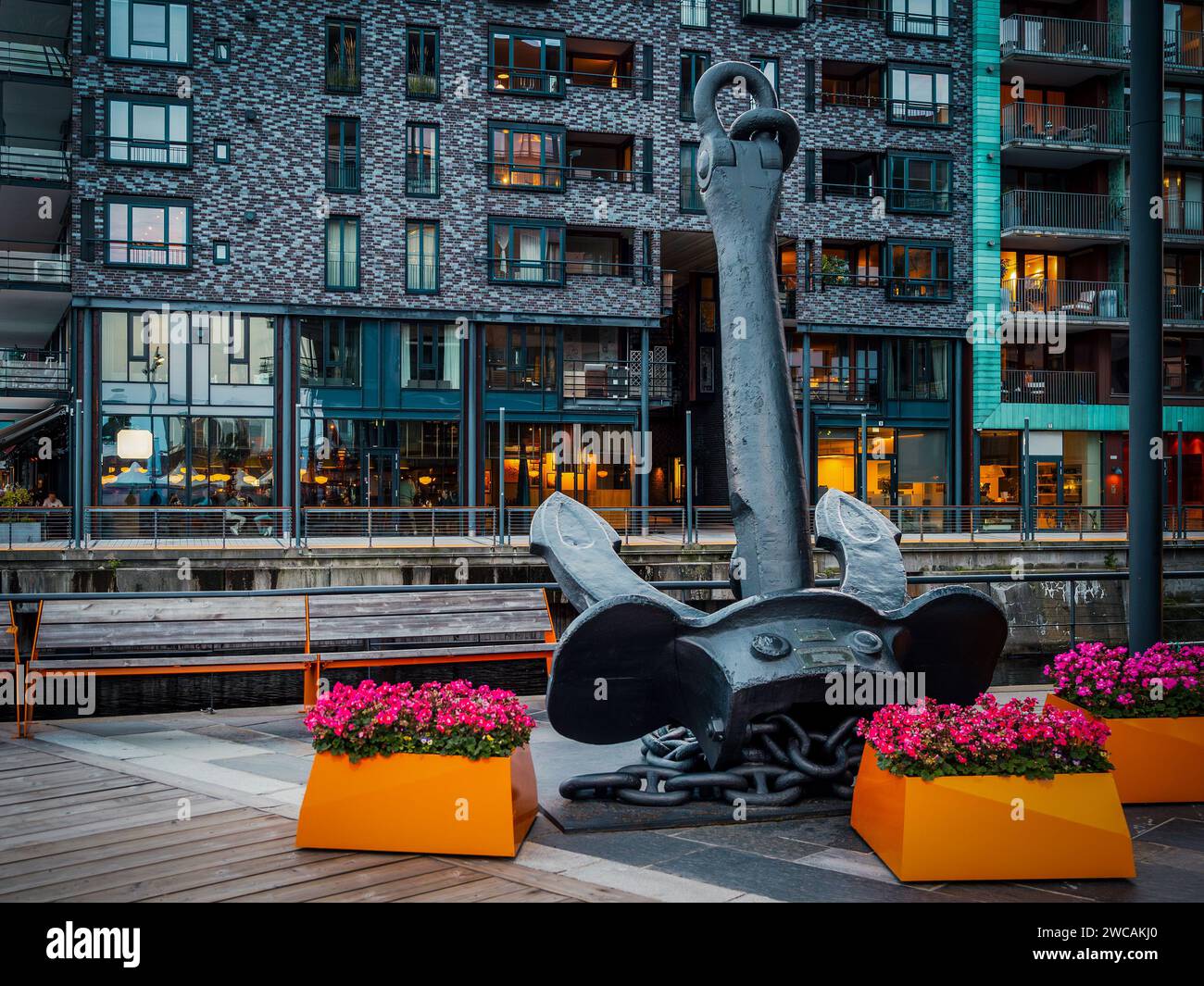 modern apartment building and big anchor as a monument on wooden ...