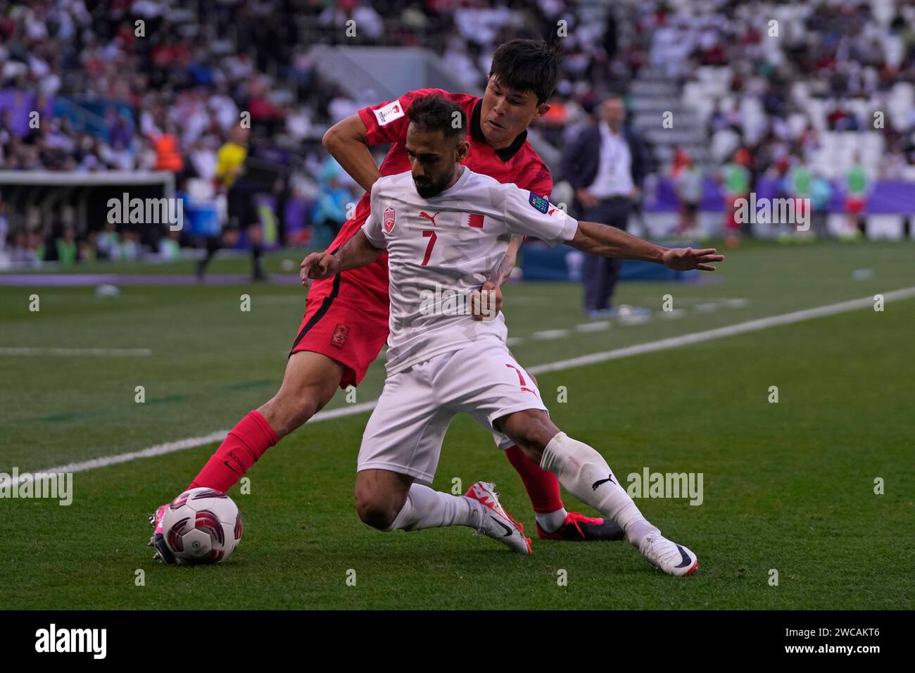 Bahrain's Ali Madan, front, is challenged by South Korea's Kim Min-jae during the Asian Cup ...