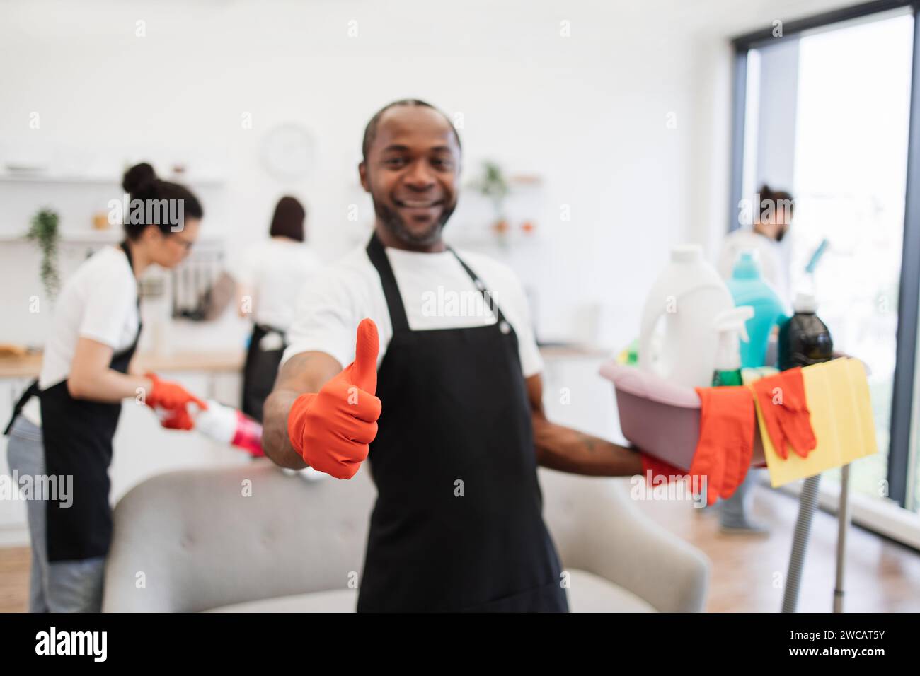 African man professional cleaning worker pointing on bucket with ...