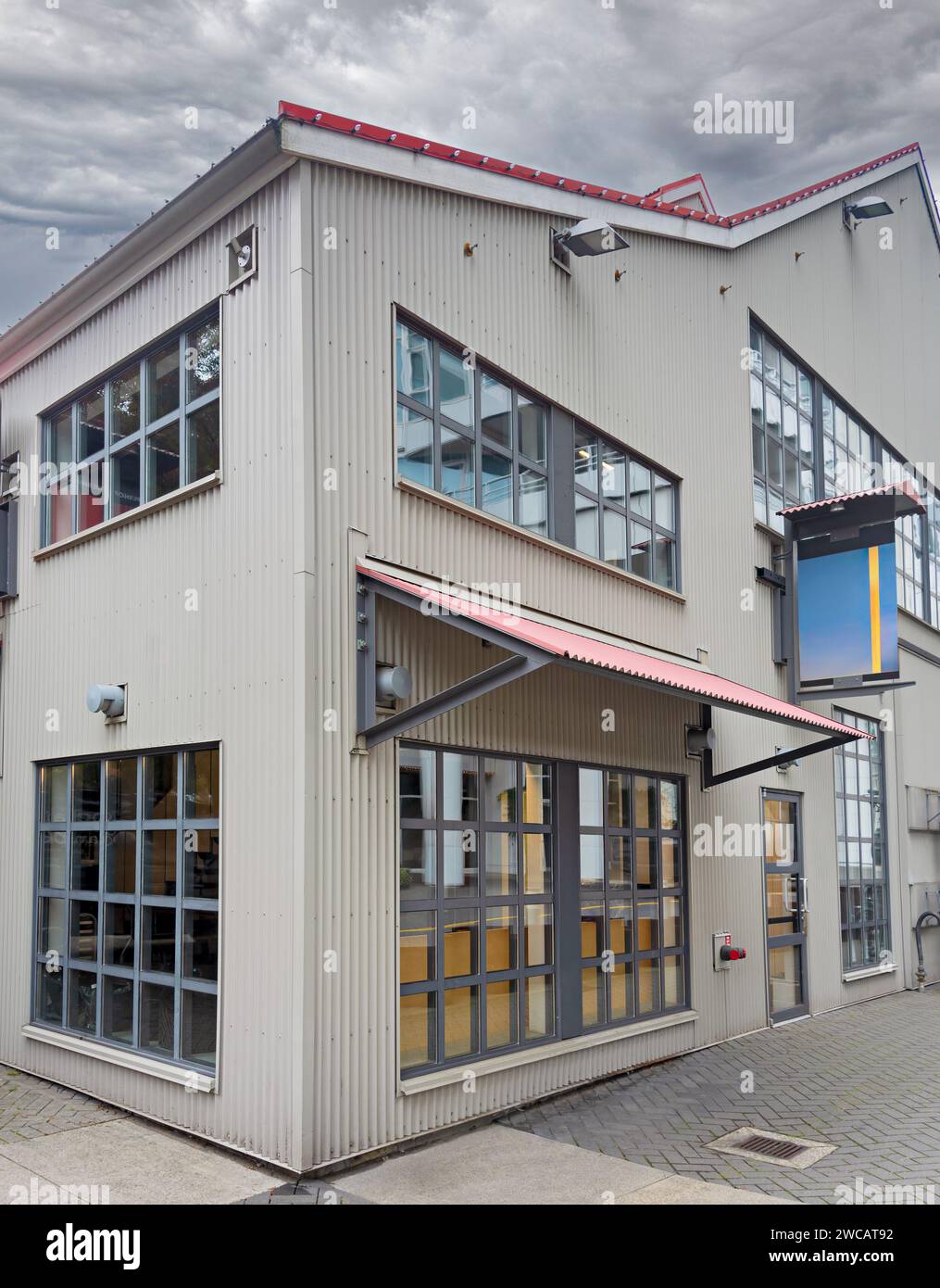 Corner of an office and production building on stormy sky background ...