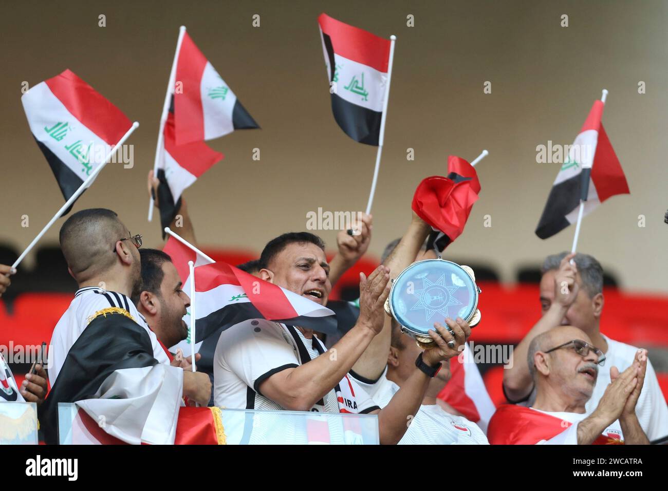 Iraqi fans wave their national flags ahead of the Asian Cup Group D ...