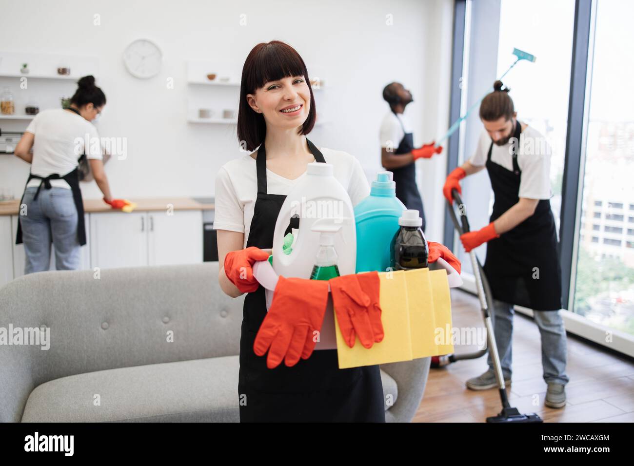 Young woman professional cleaning worker holding a bucket with ...