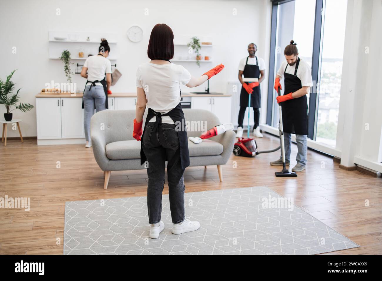 Female boss of company distributes tasks to employees Stock Photo - Alamy