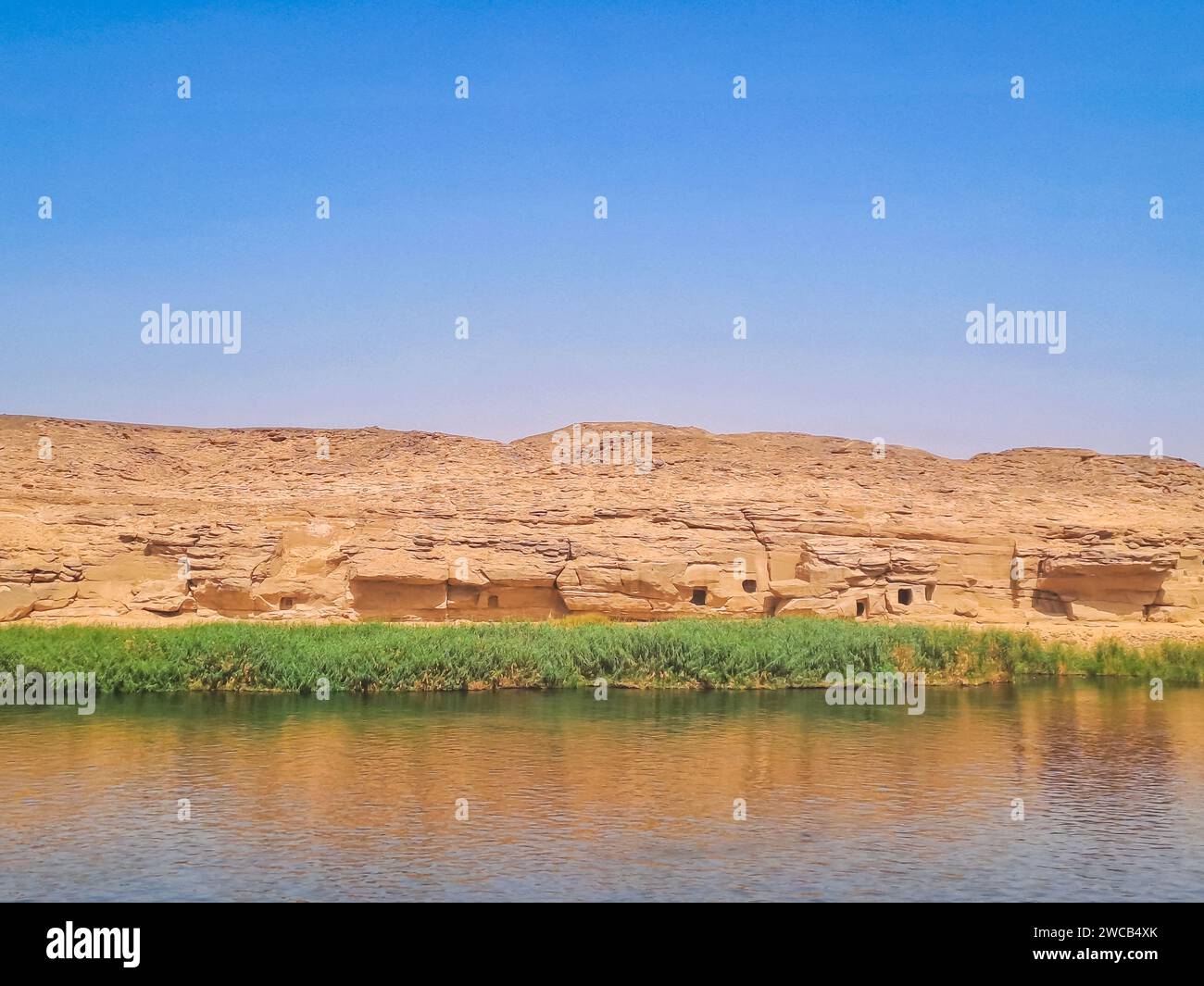 Aswan view on the Nile river and the tombs of nobles with a blue sky ...