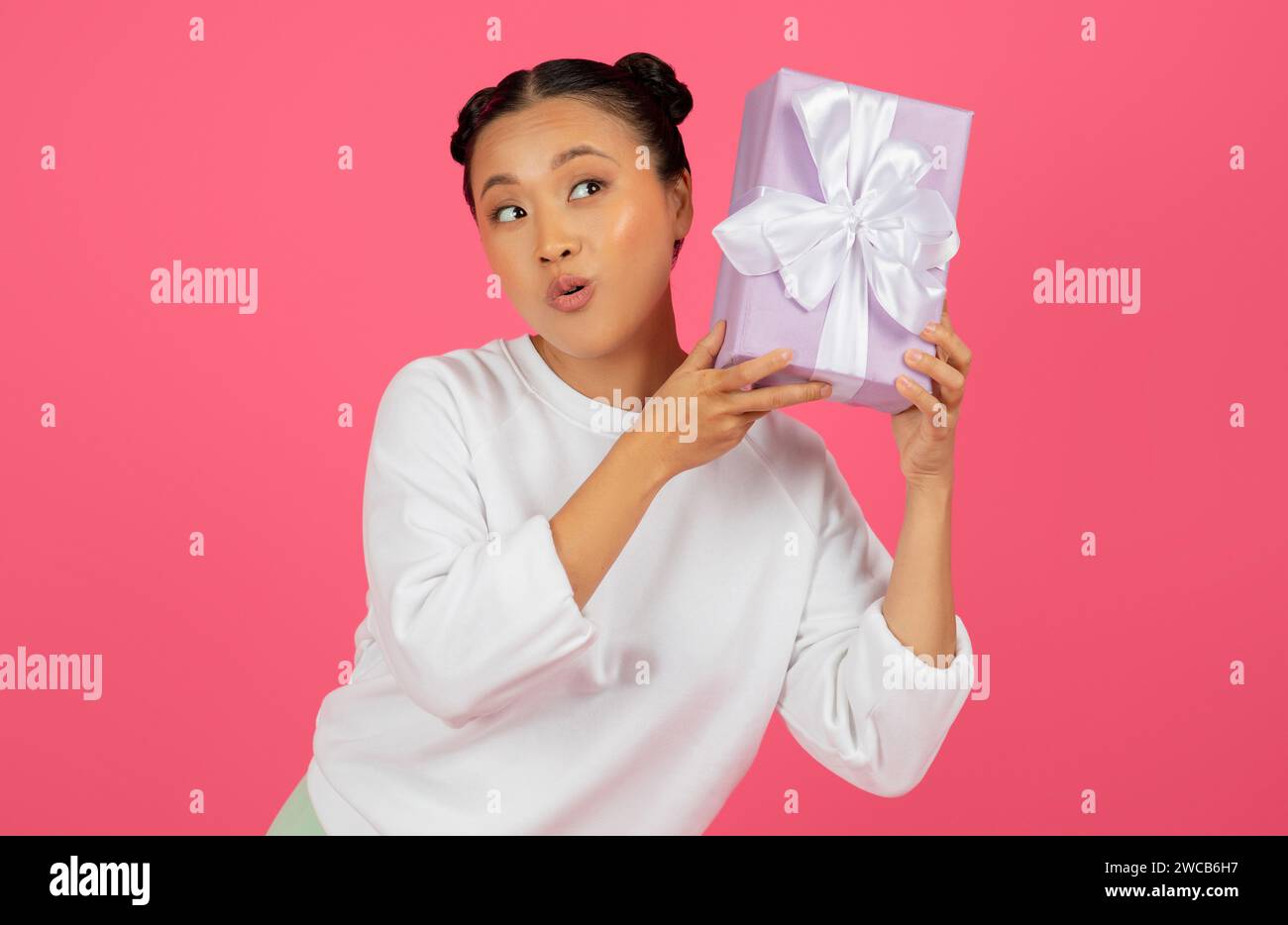 Surprise Gift. Excited Young Asian Woman Shaking Wrapped Box With ...