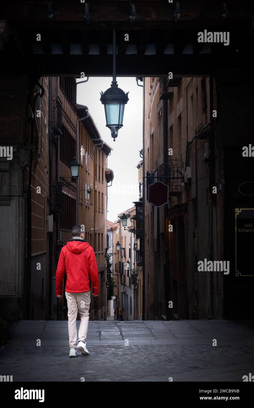 Low-key photography, depicting a young man walking towards a street ...
