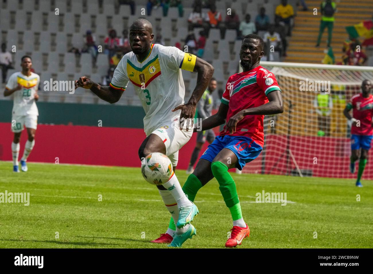 Senegal's Kalidou Koulibaly, left, fights for the ball with Gambia's ...