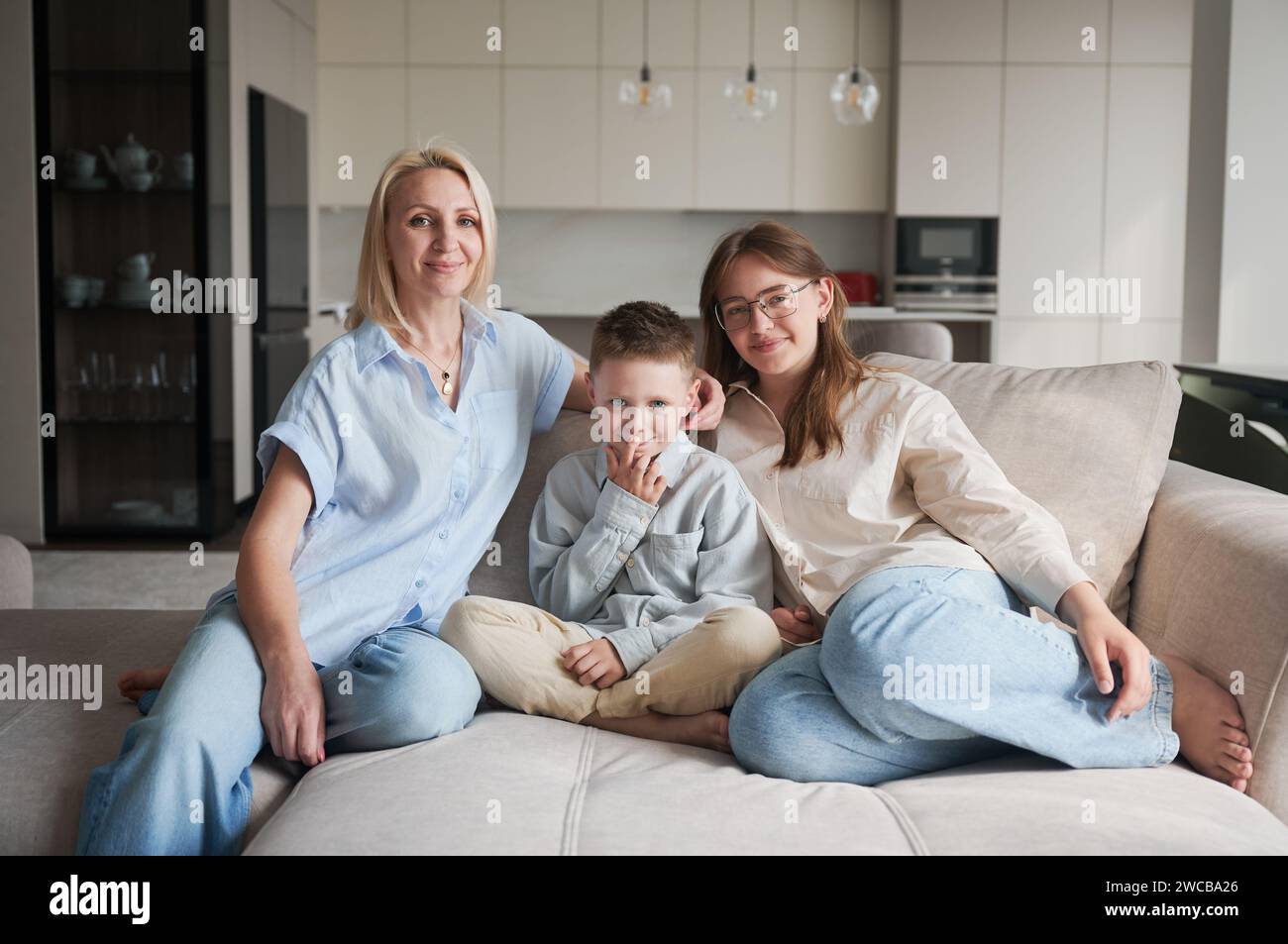 Cozy afternoon in family circle. Joyful children relaxing on couch with ...