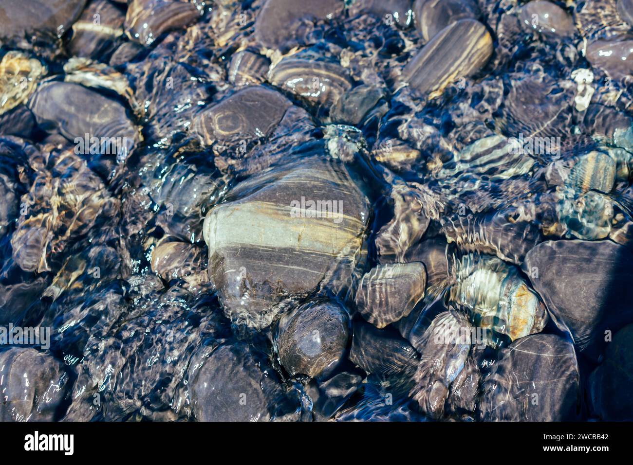 Black round stones on the coast in Lipe Island, Thailand. Pebbles ...