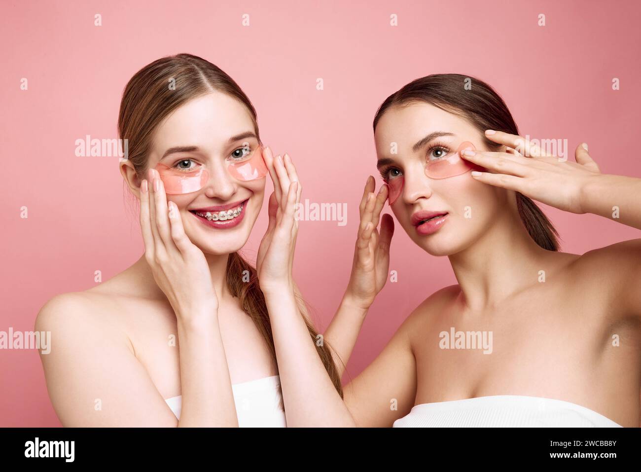 Radiant Rituals. Portrait of two young attractive girls applying under ...