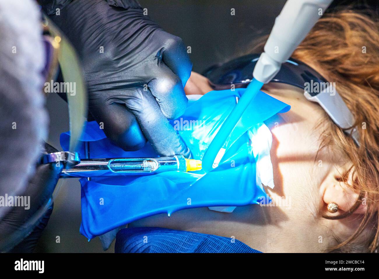 dentist giving an anesthesia injection to a patient's pus before his ...