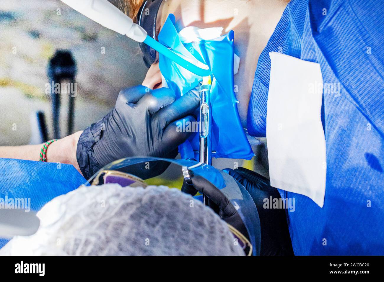 give an injection of anesthesia to a sick woman before his treatment ...