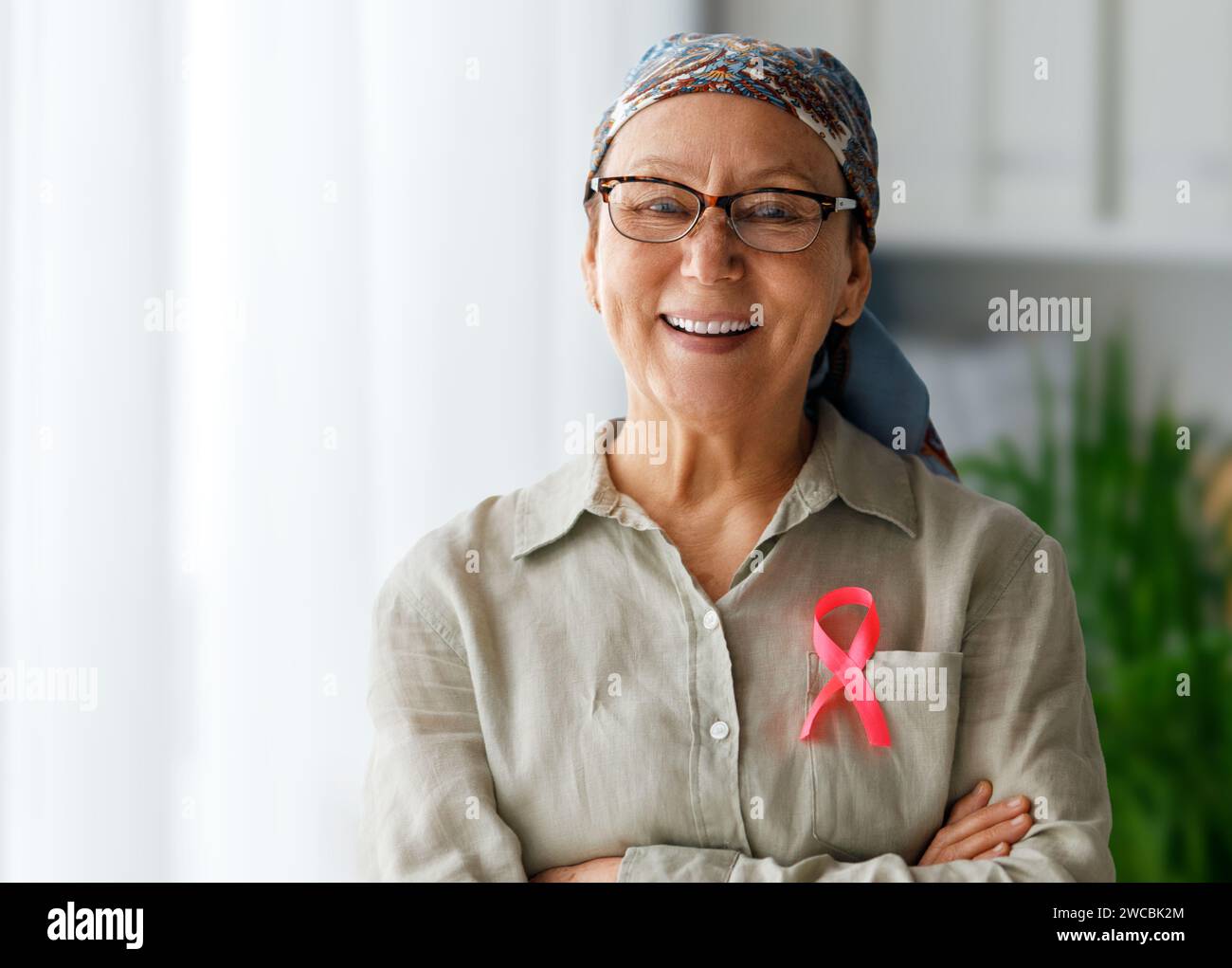 Female patient standing near window and smiling. Raising knowledge on ...