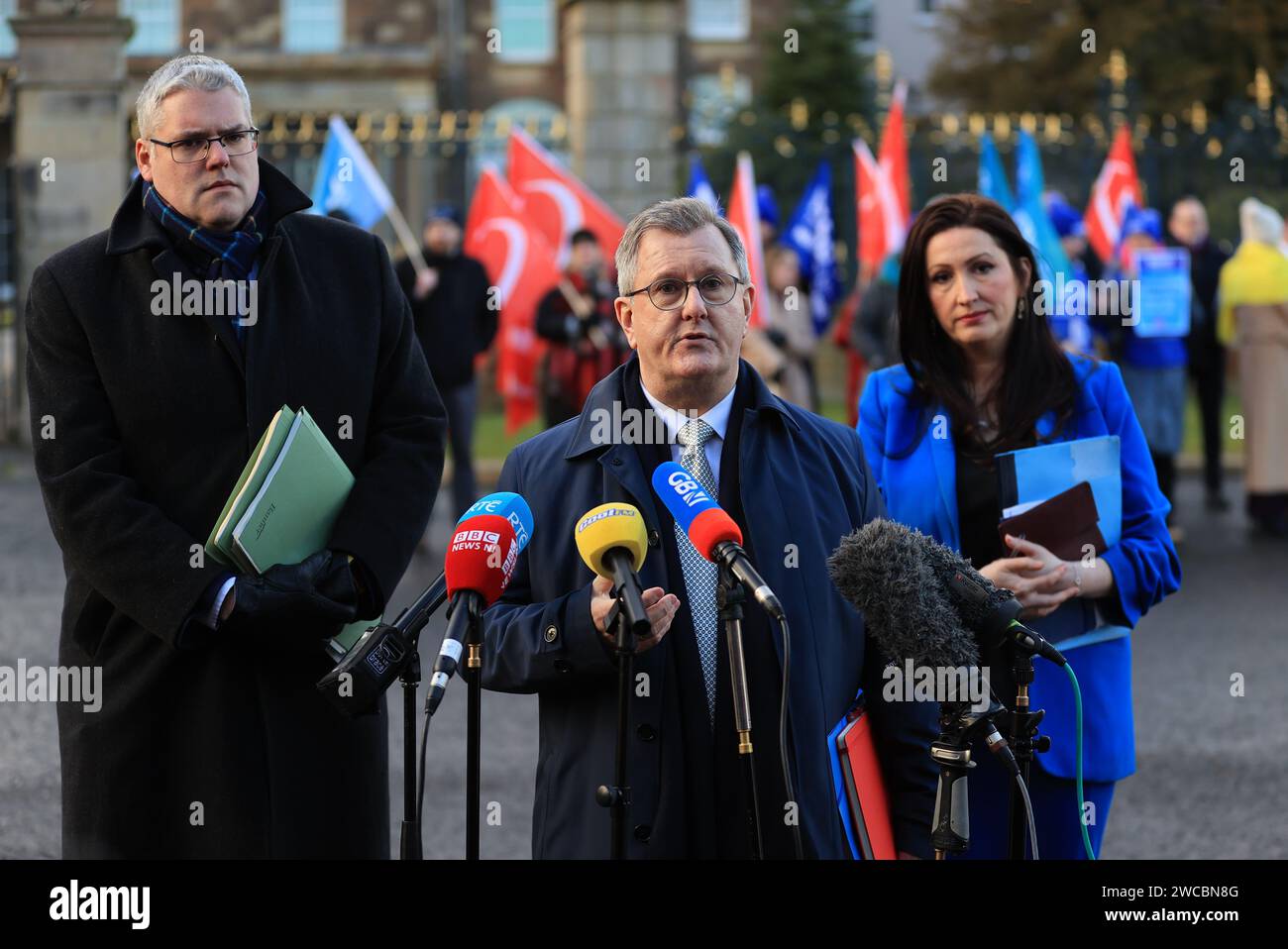 DUP leader Sir Jeffrey Donaldson (centre) speaking to the media with ...