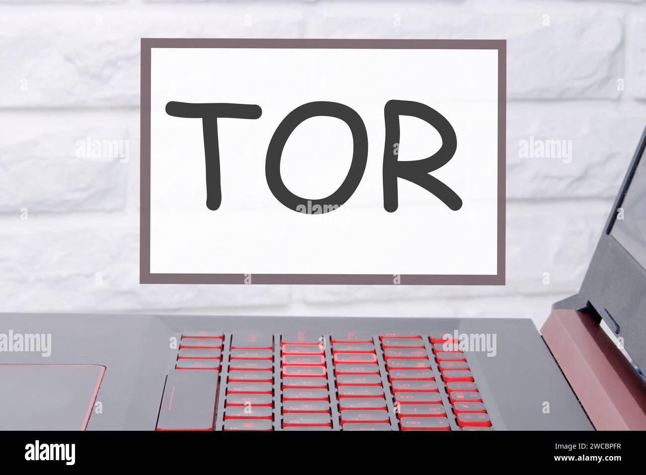 the word TOR an inscription on a magnetic board hanging on a brick wall ...