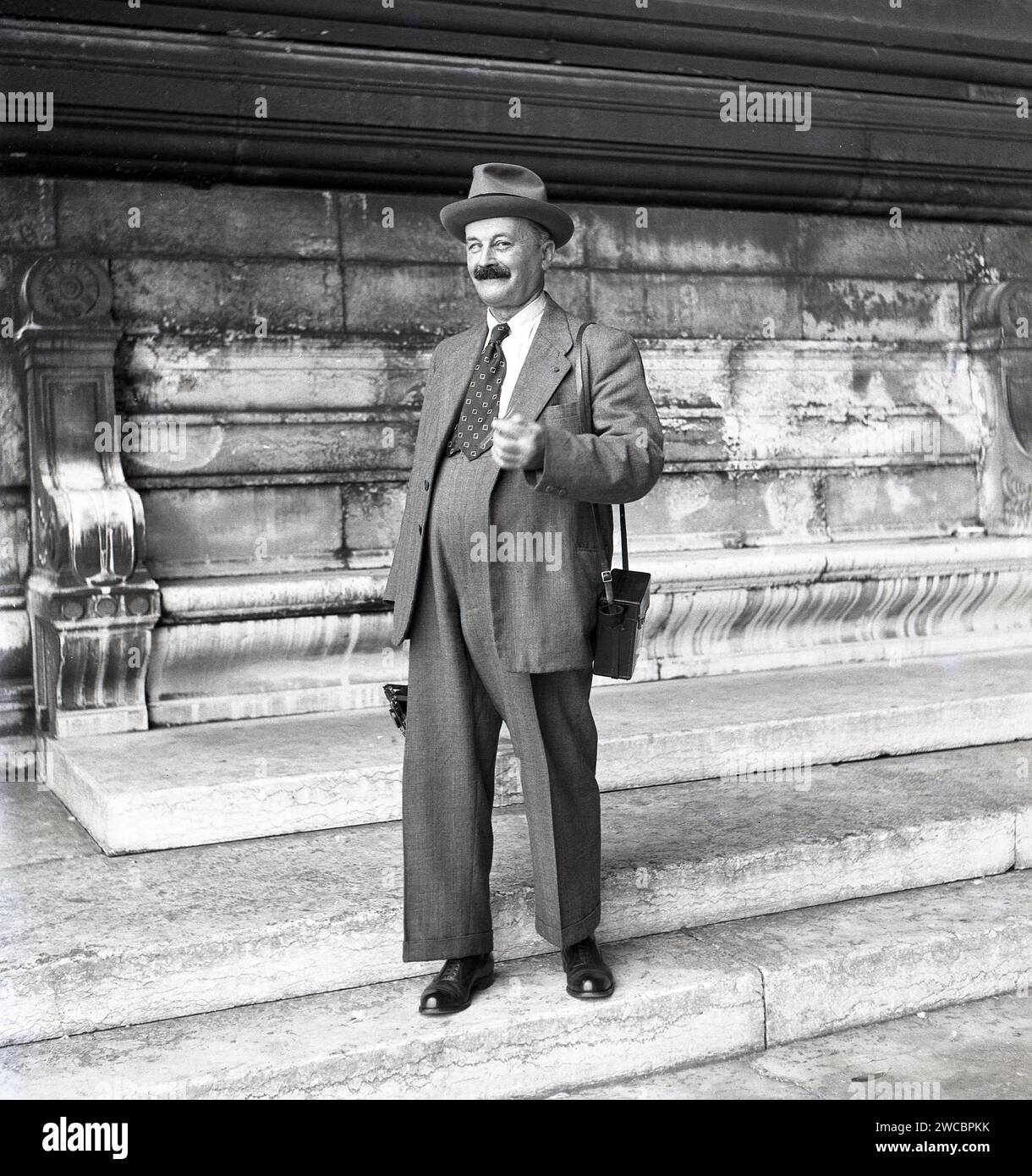 1950, historical, tourist, portly gentleman in a suit & tie and hat ...