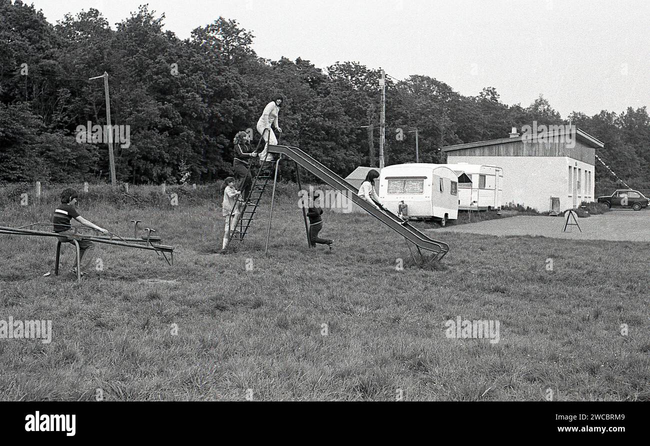 1960s, historical, childrens playing on slide at a camping/caravan spot ...