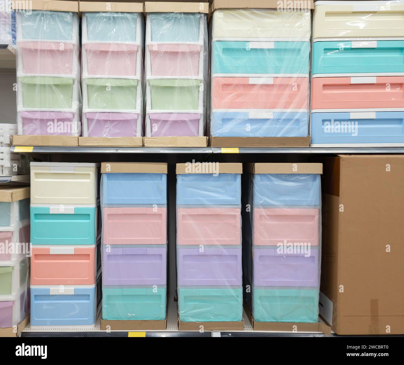 Colorful plastic drawers on shelves a department store Stock Photo - Alamy