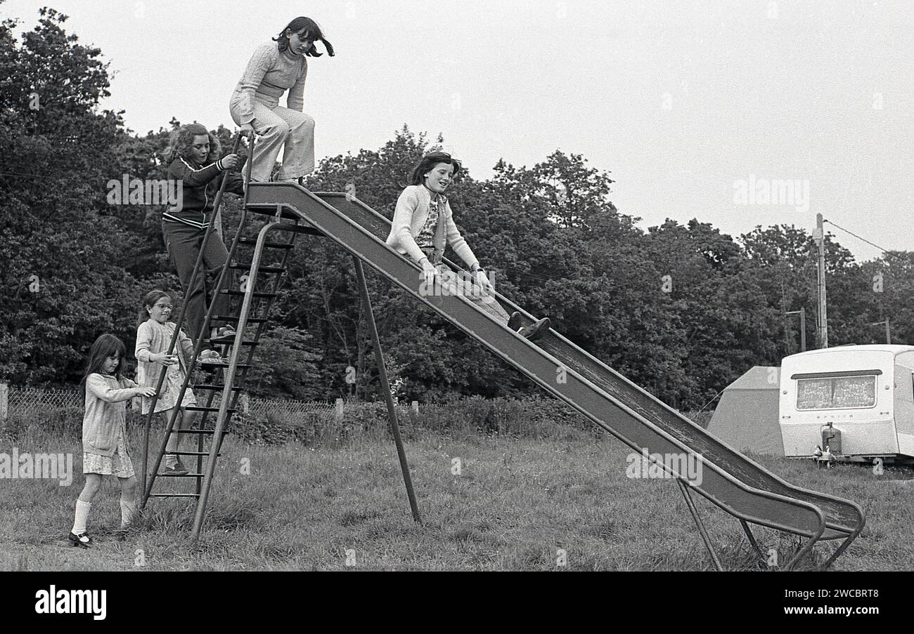 1960s, historical, childrens playing on slide at a camping/caravan spot ...