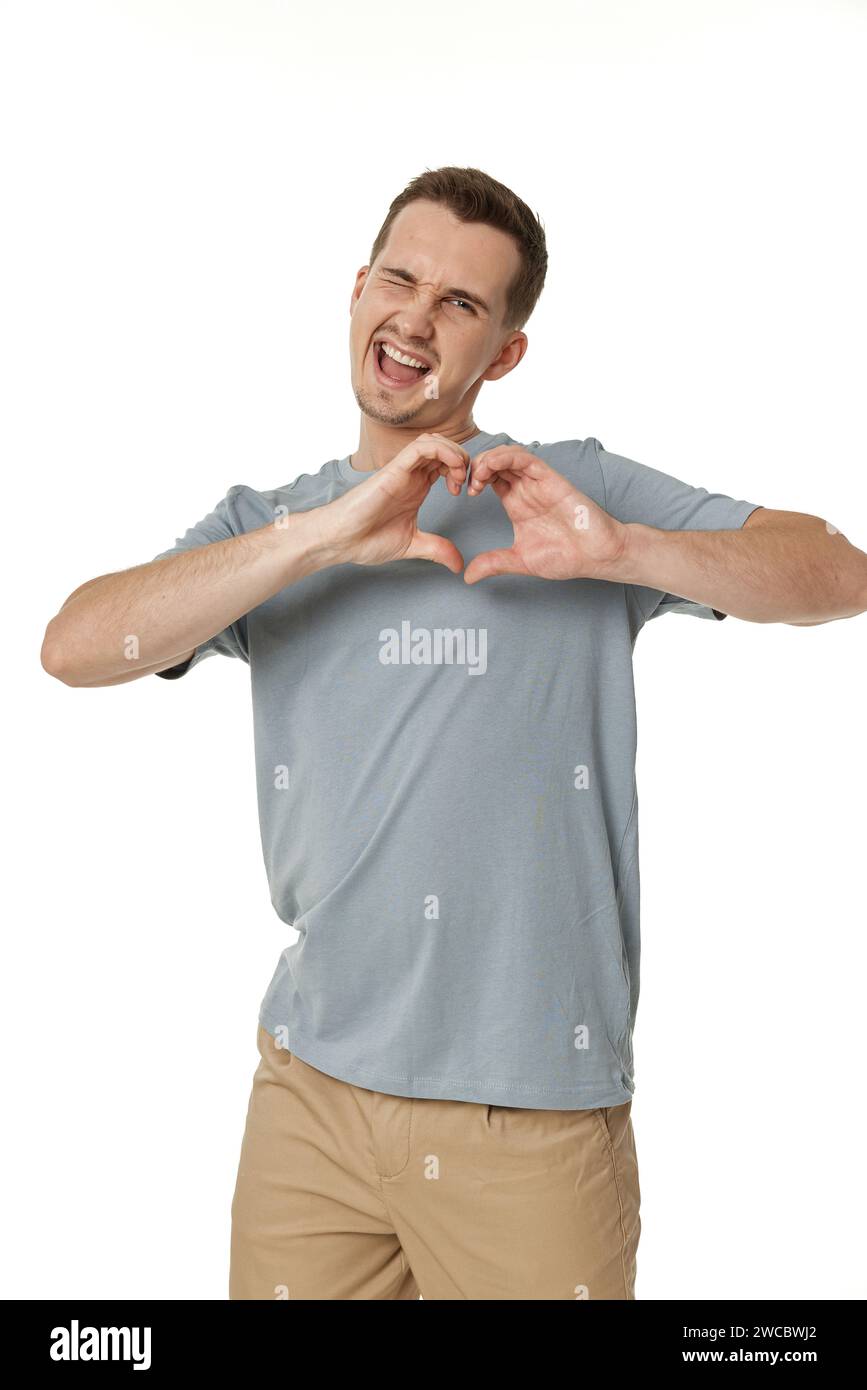 Young man doing heart symbol shape with hands Stock Photo - Alamy