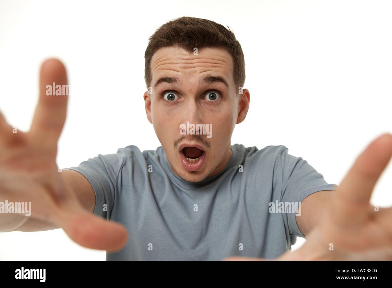 surprised guy looking at camera on white studio background Stock Photo ...