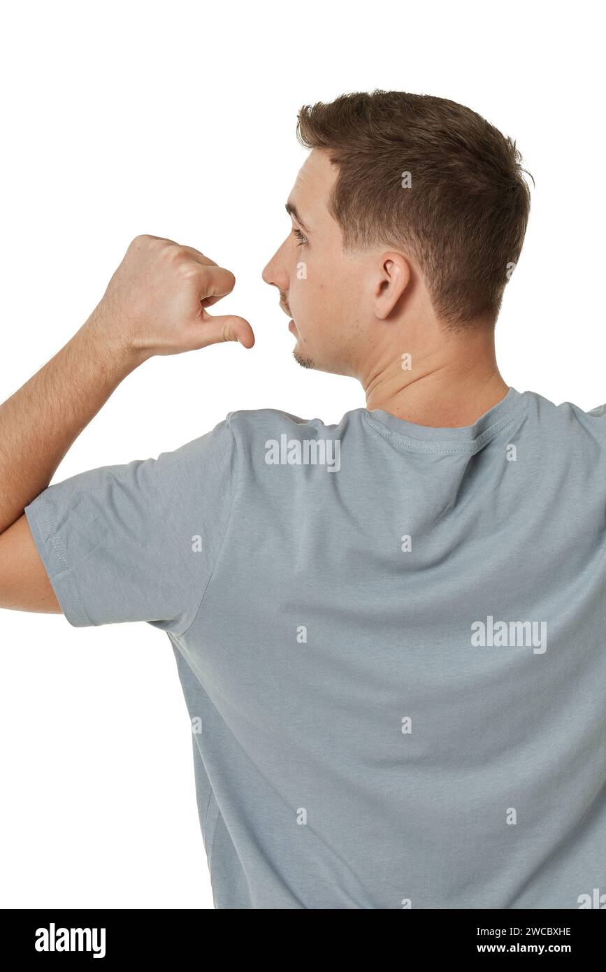 happy guy looking pointing to his back on white studio background Stock ...