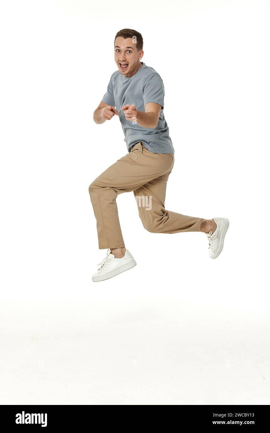 happy guy looking pointing at the camera on white studio background ...