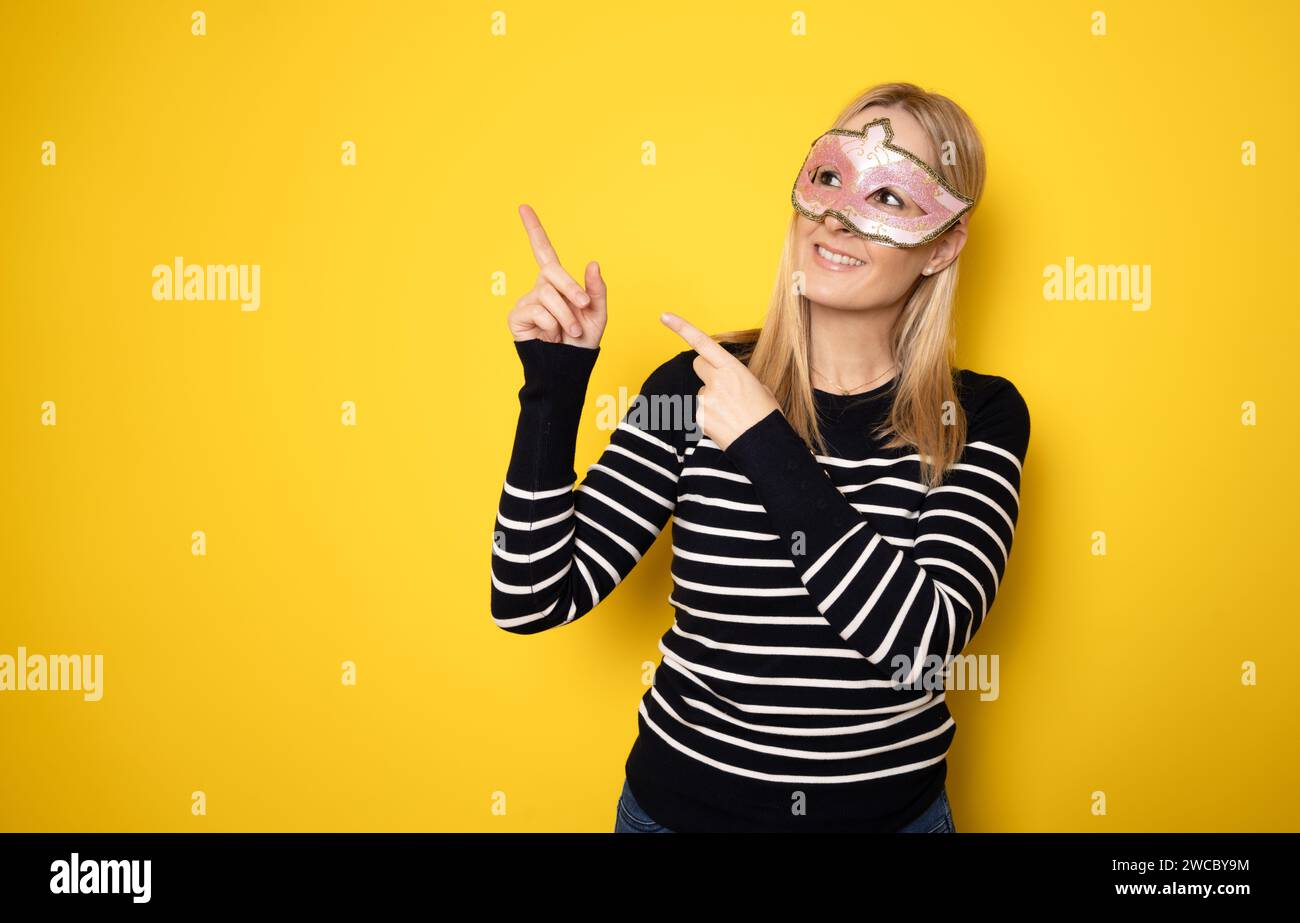 Portrait of attractive beautiful young woman wearing carnival mask ...