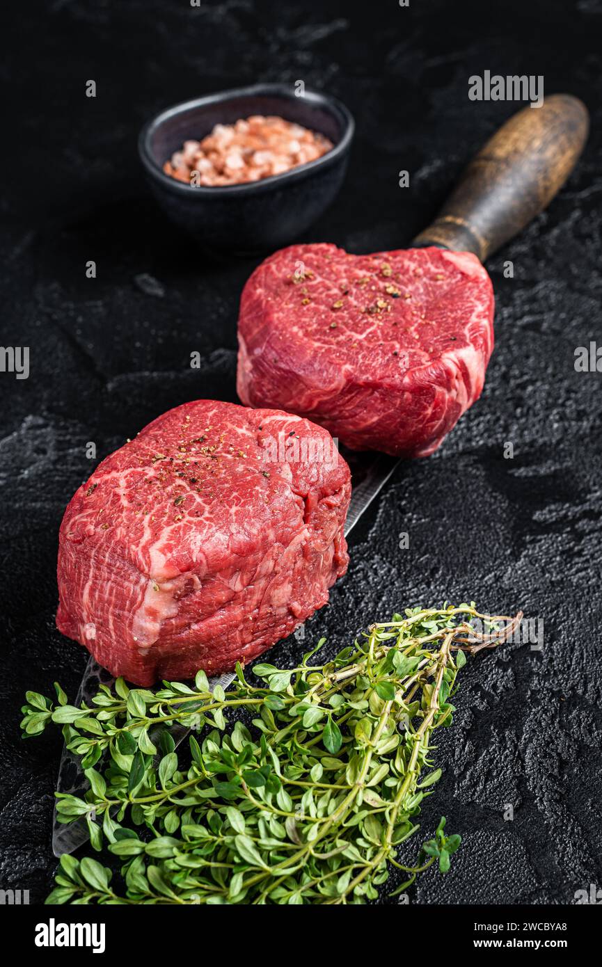 Fillet Mignon Beef steak, raw dry aged marble meat. Black background ...