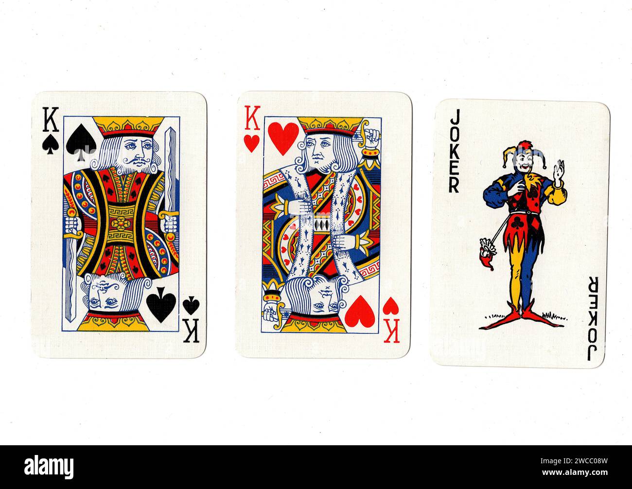 Vintage playing cards showing a pair of kings and a joker isolated on a ...