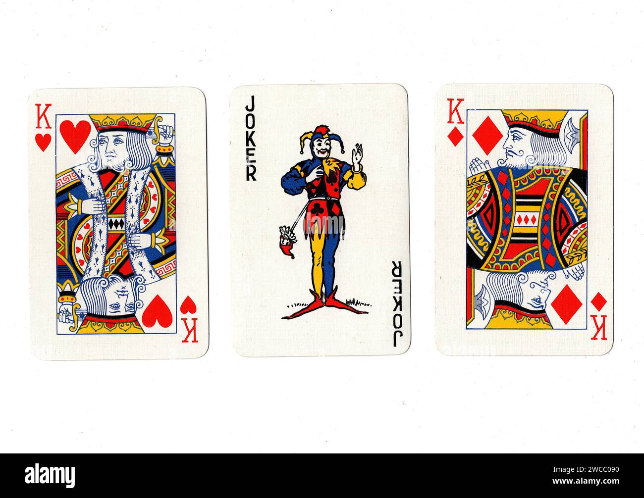 Vintage playing cards showing a pair of red kings and a joker isolated ...