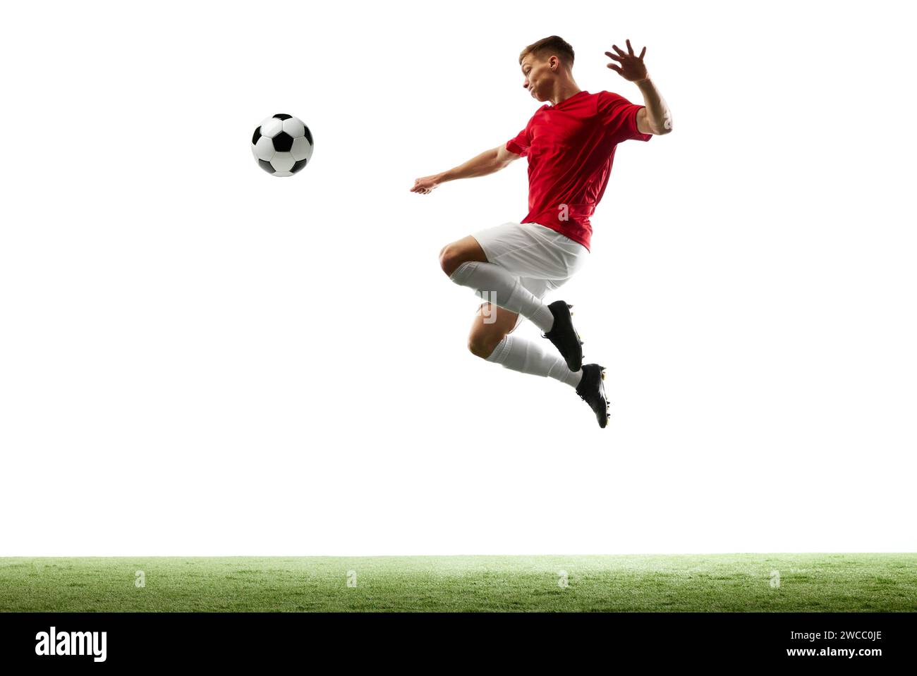 Perfect air kick. Professional soccer player sends ball soaring through ...