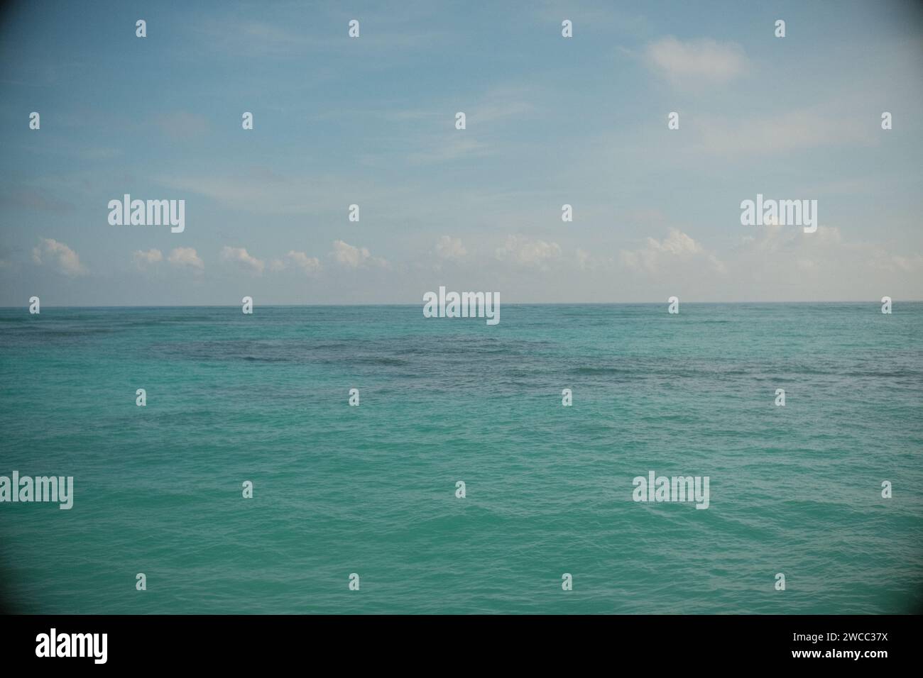 Blue sky with clouds over ocean waves with sand hi-res stock ...