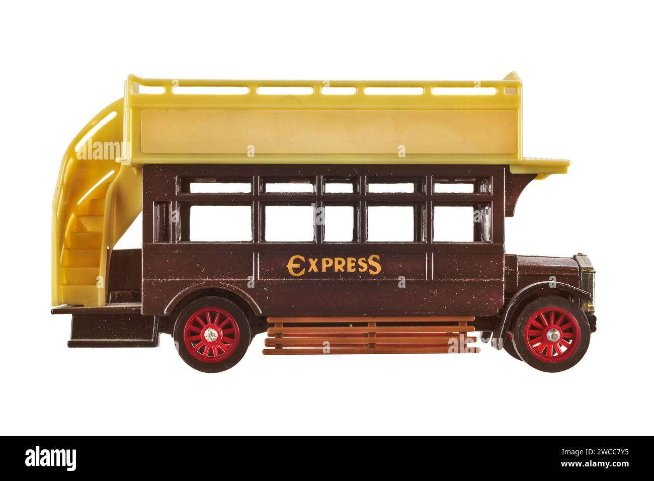 Ancient brown double-decker bus toy isolated on a white background ...