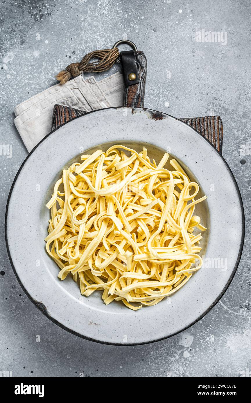 Raw dried spaetzle egg noodle. Gray background. Top view Stock Photo ...