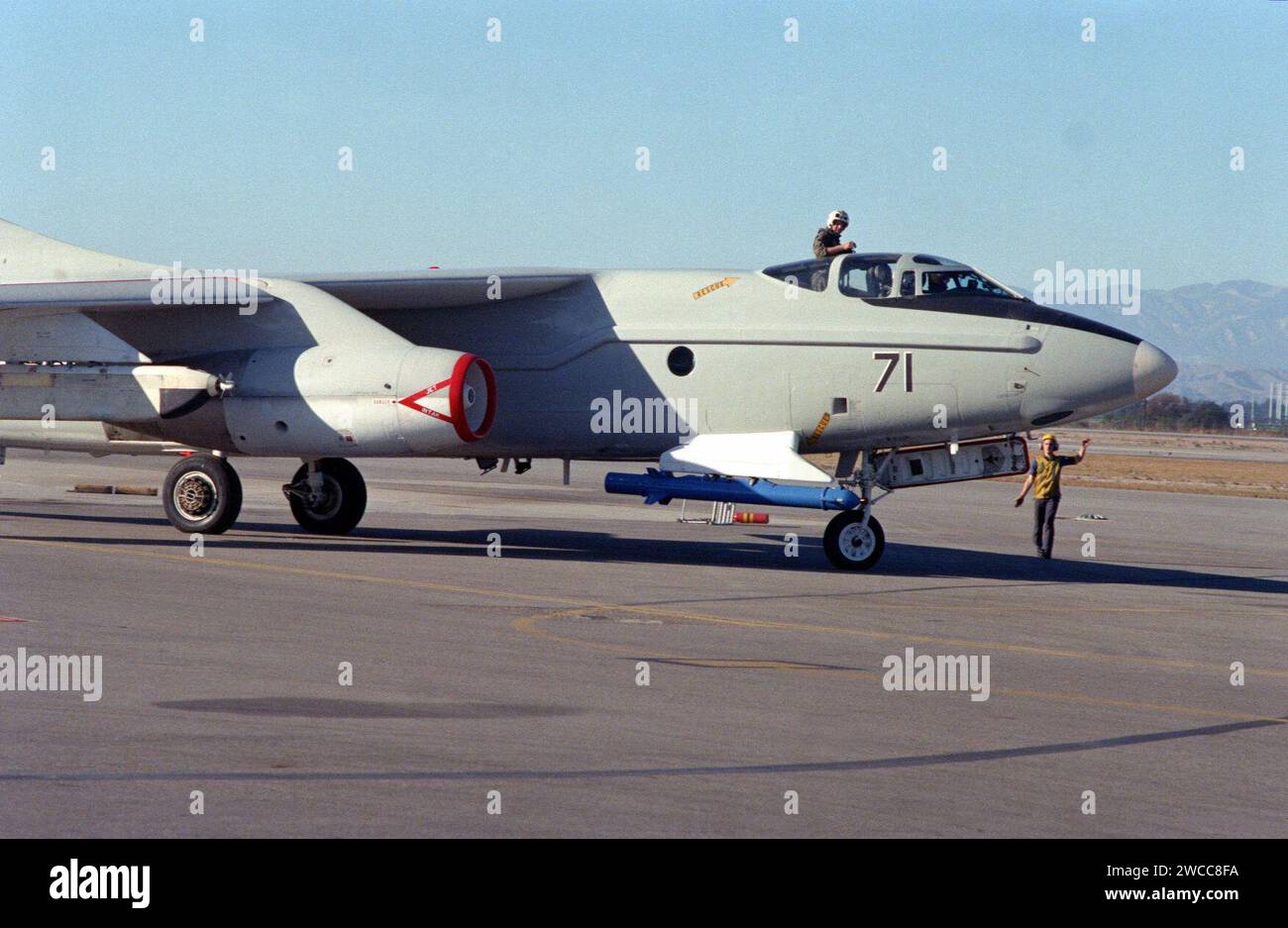 A preflight check is performed on a parked A-3 Skywarrior aircraft ...